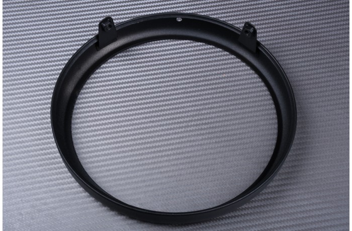 Casing for round headlight casing, to be adapted