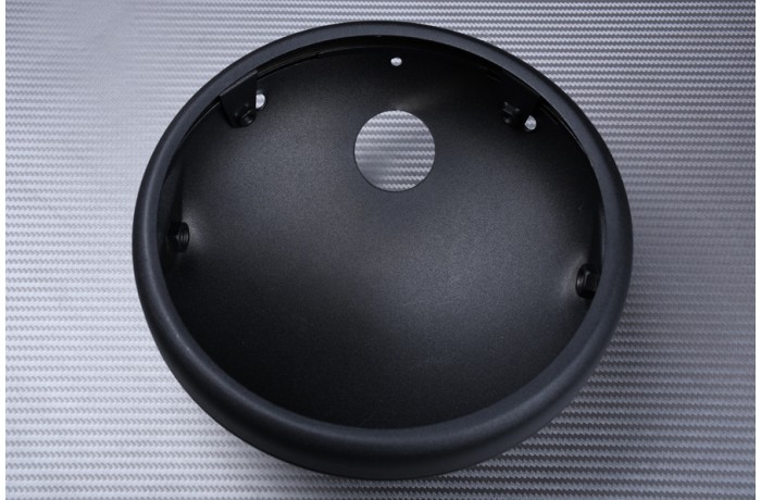 Casing for round headlight casing, to be adapted